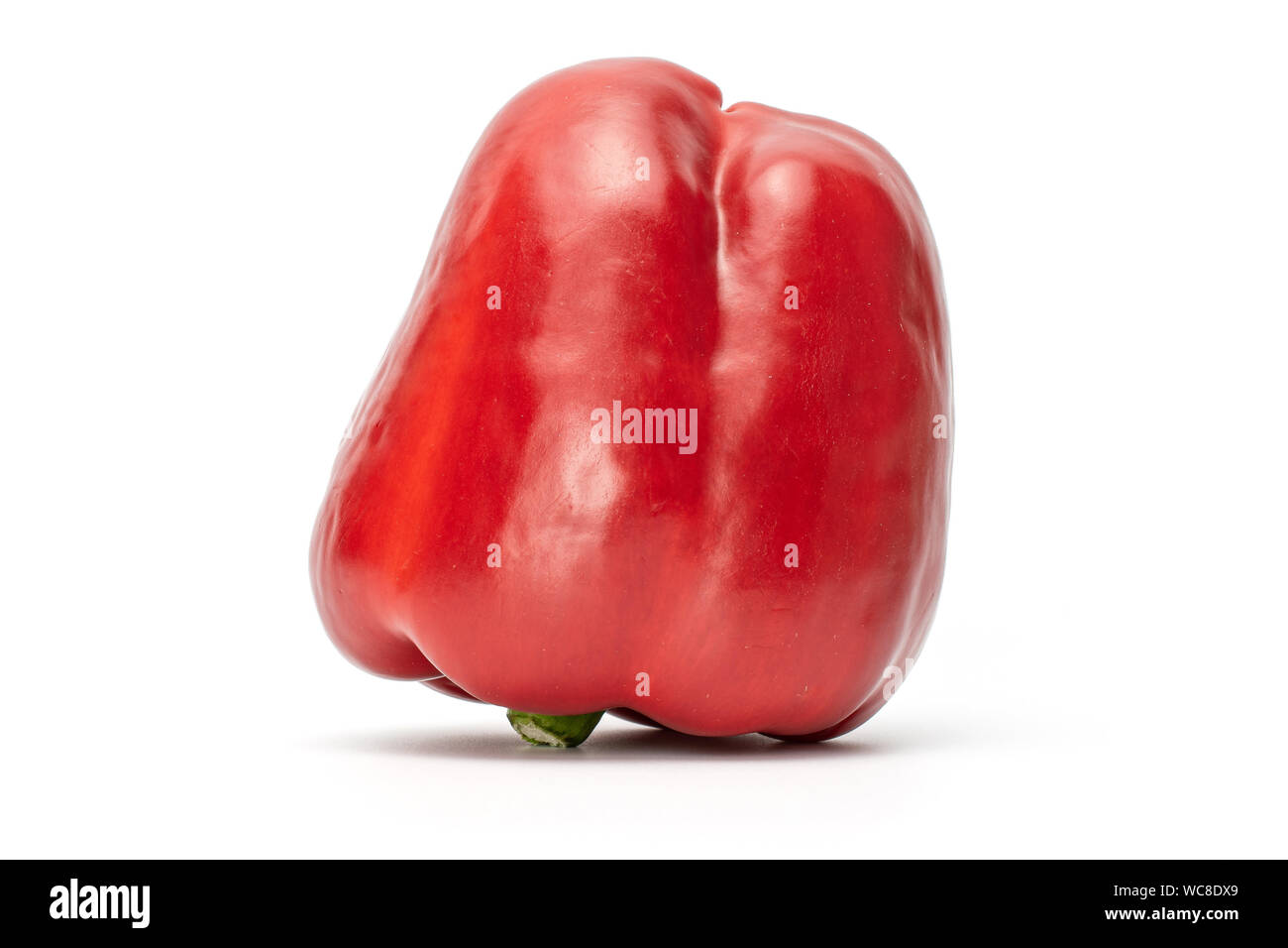 One whole red bell pepper flipped over isolated on white background ...