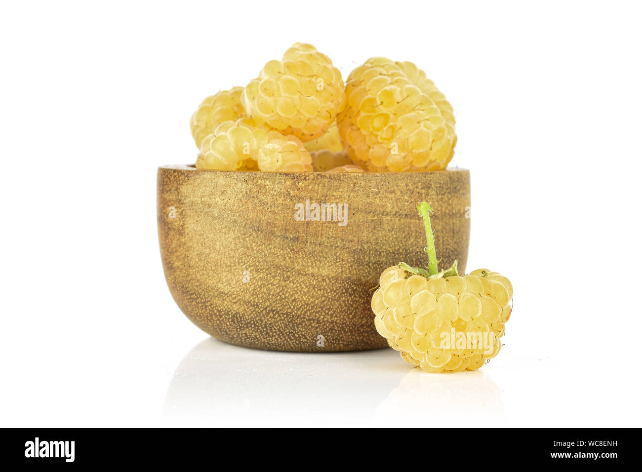 Lot of whole ripe fresh golden hymalayan raspberry in wooden bowl ...