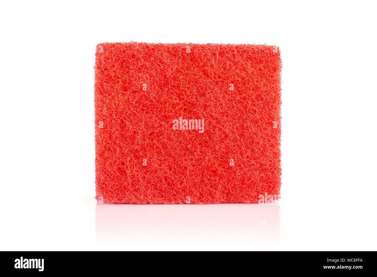 One whole red cleaning kitchen sponge isolated on white background ...