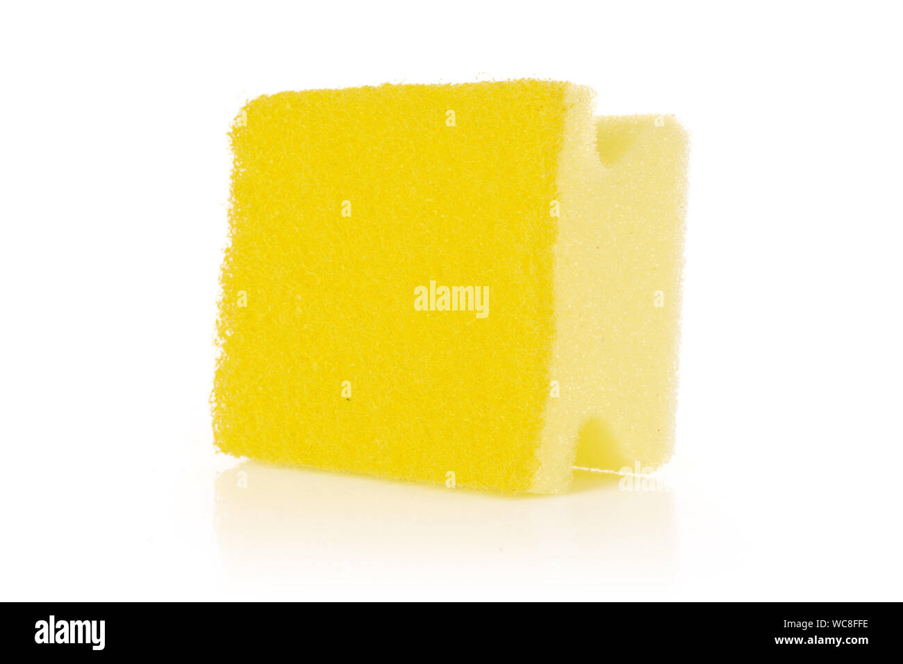 One whole yellow cleaning kitchen sponge letter shape isolated on white ...