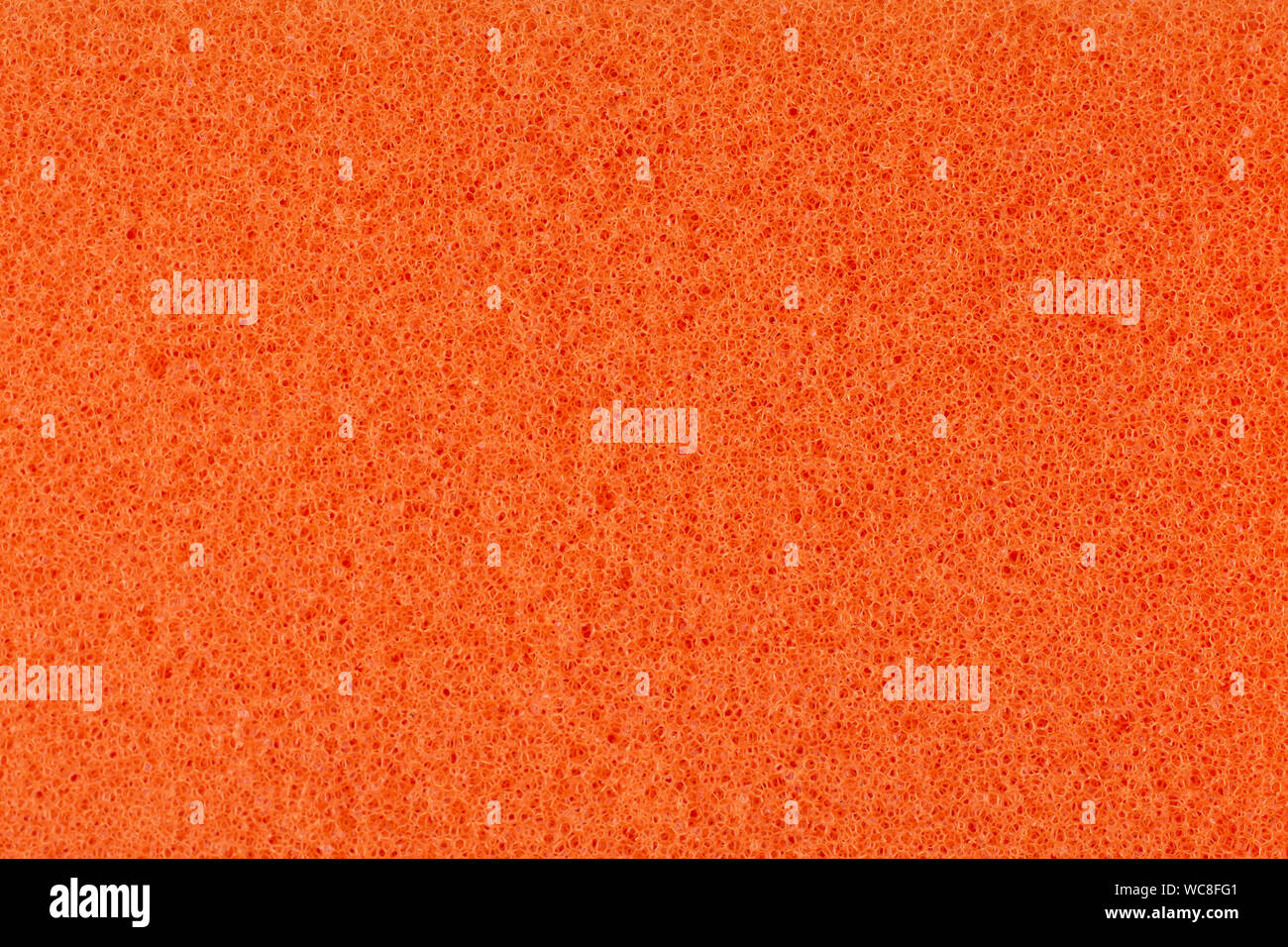 Orange cleaning kitchen sponge macro isolated Stock Photo - Alamy