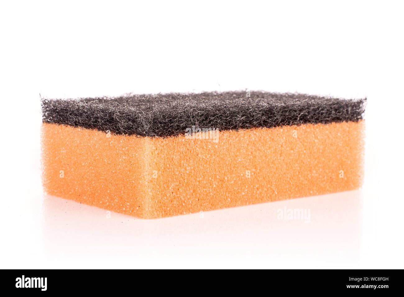 One whole orange cleaning kitchen sponge isolated on white background ...