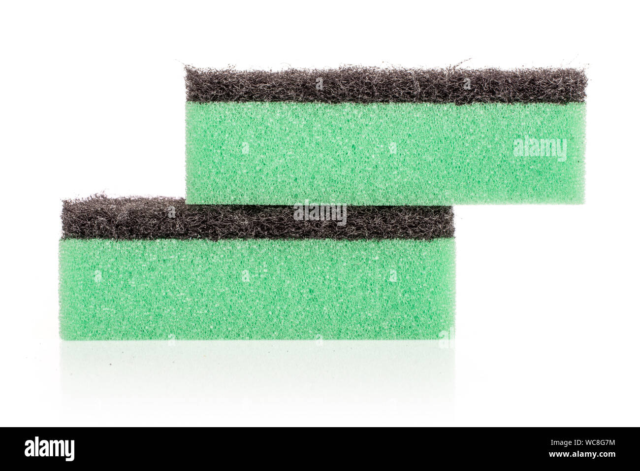 Group of two whole green cleaning kitchen sponge isolated on white ...