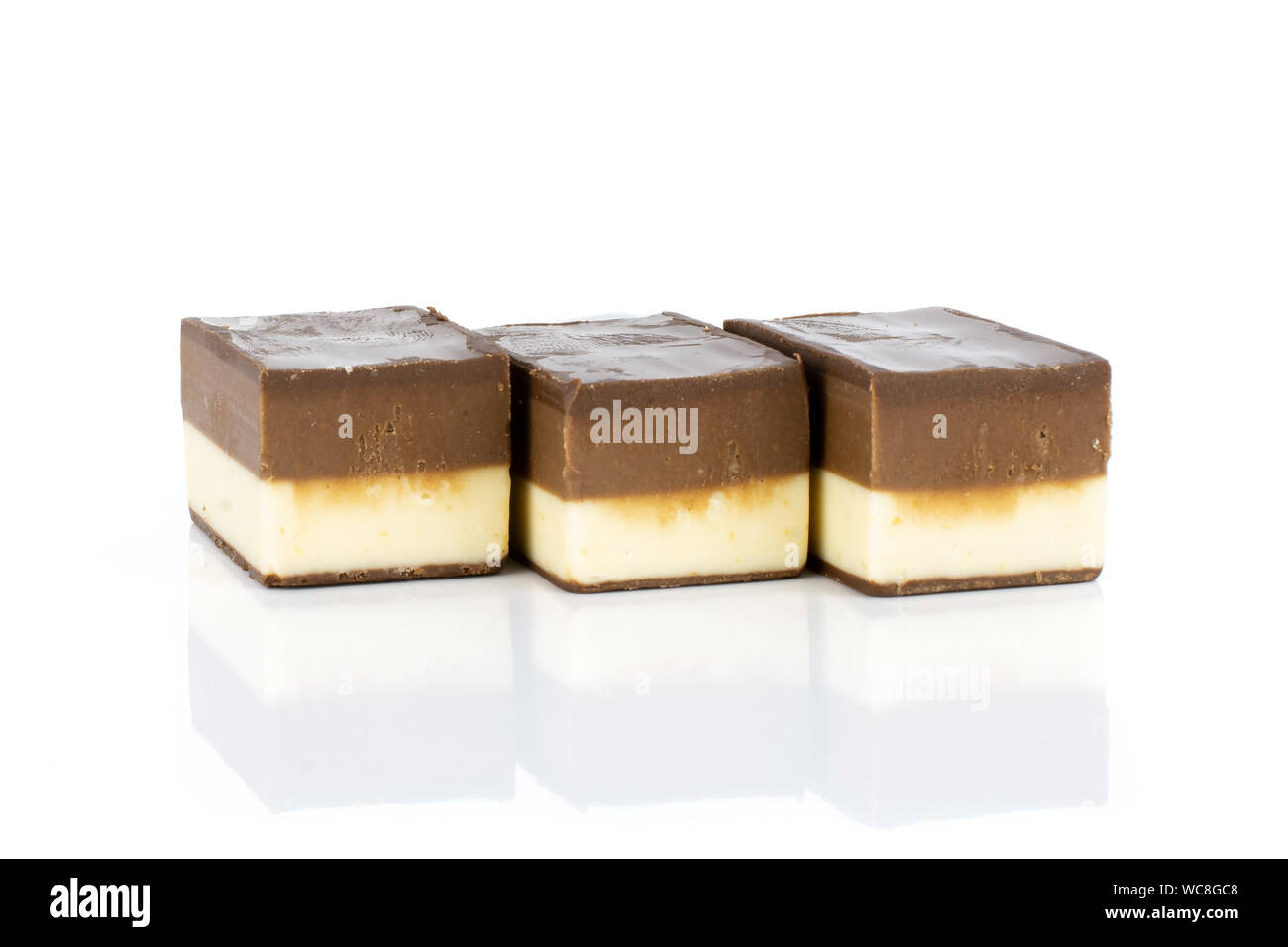 Group of three whole mellow two coloured nougat piece in row isolated ...