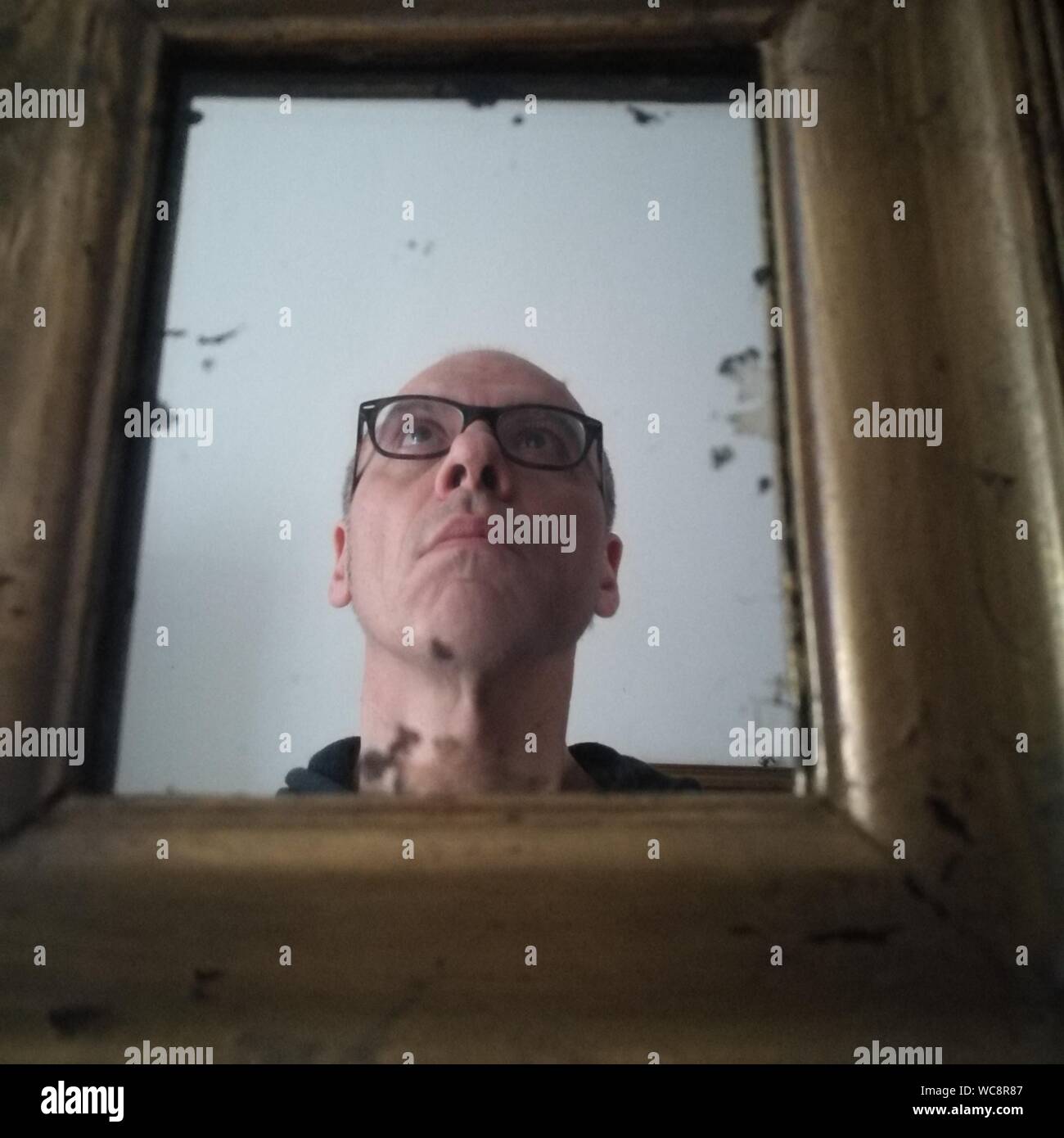 Man reflected in mirror thinking hi-res stock photography and images ...