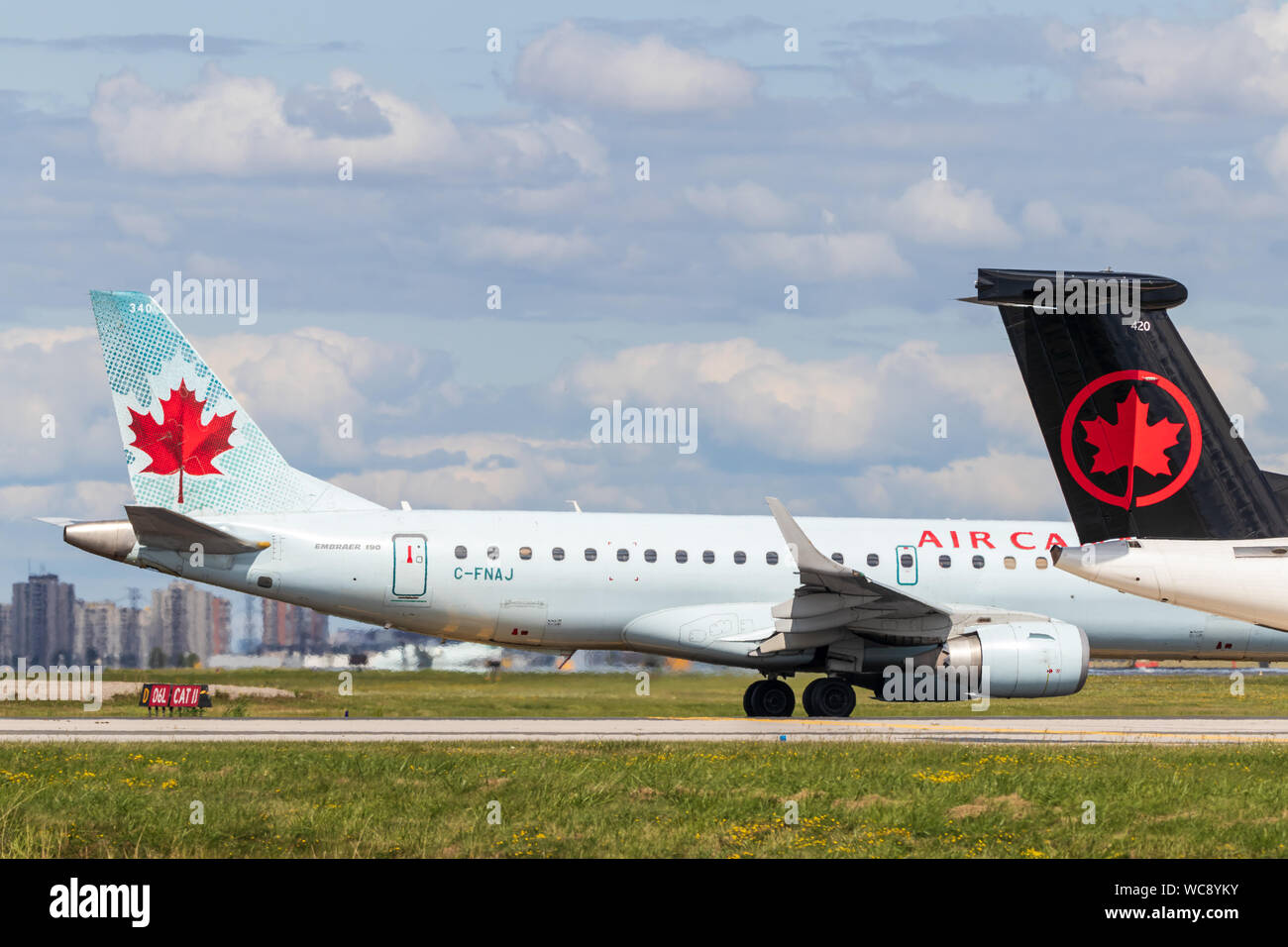 Two Air Canada tails (old livery and new livery) holding short beside ...