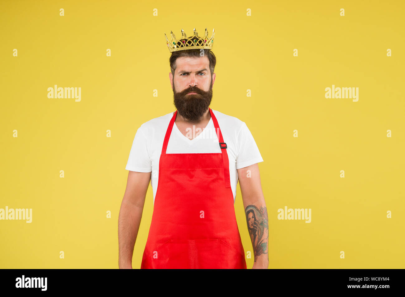 King of kitchen. Cook with beard and mustache yellow background. Man ...