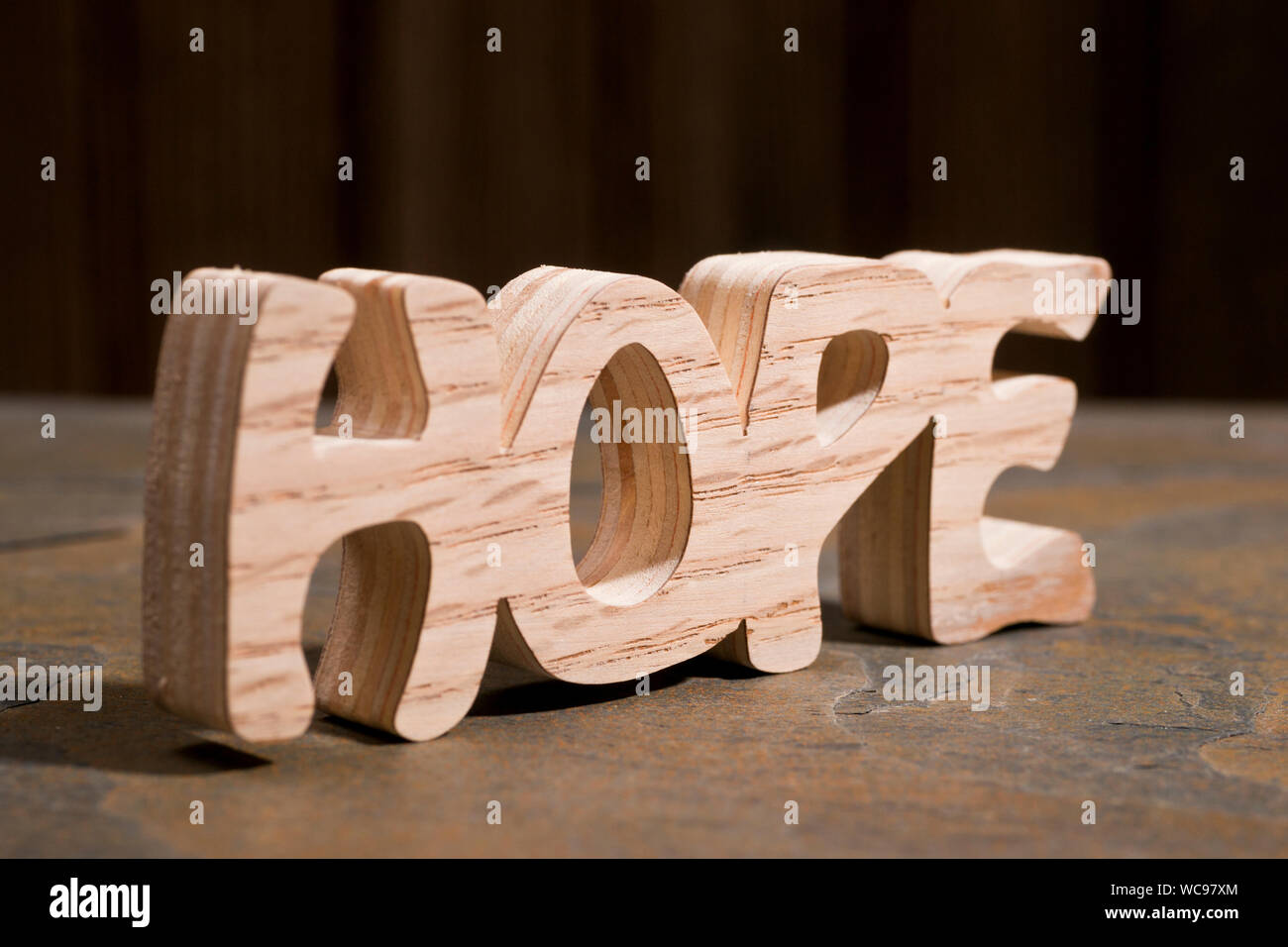 Single word HOPE hand cut from wood Stock Photo - Alamy