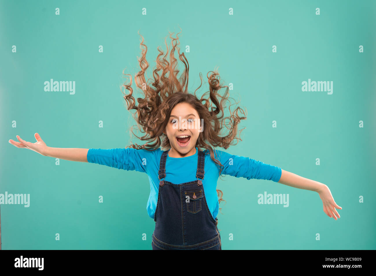 Feeling active and energetic. Energetic little girl with long brunette ...