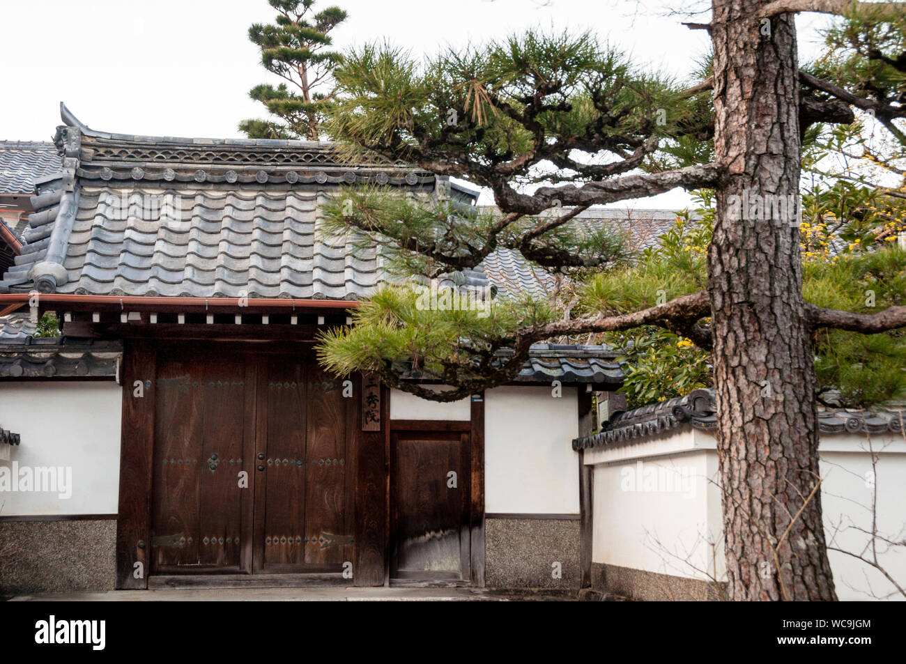 Wooden gate in Kyoto Japan with a traditional kawara roof Stock Photo ...