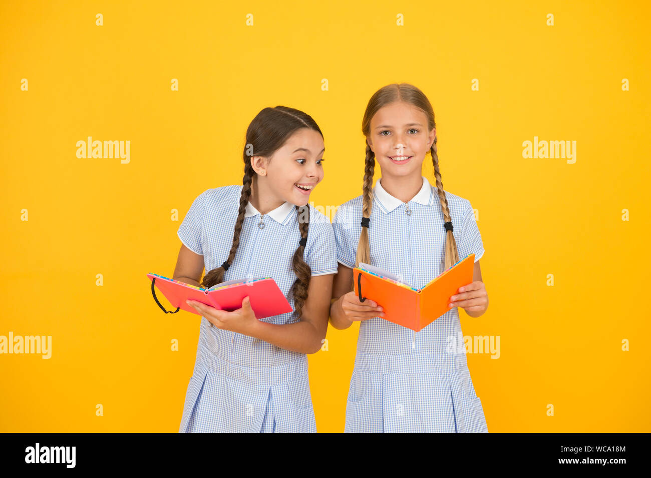 Reading and retelling. Small children holding books yellow background ...