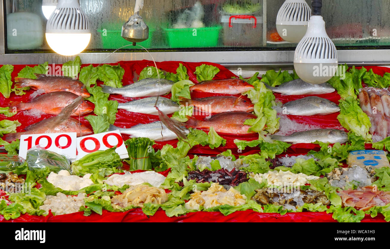 A seafood restaurant displays fresh fish and seafood for customers to ...
