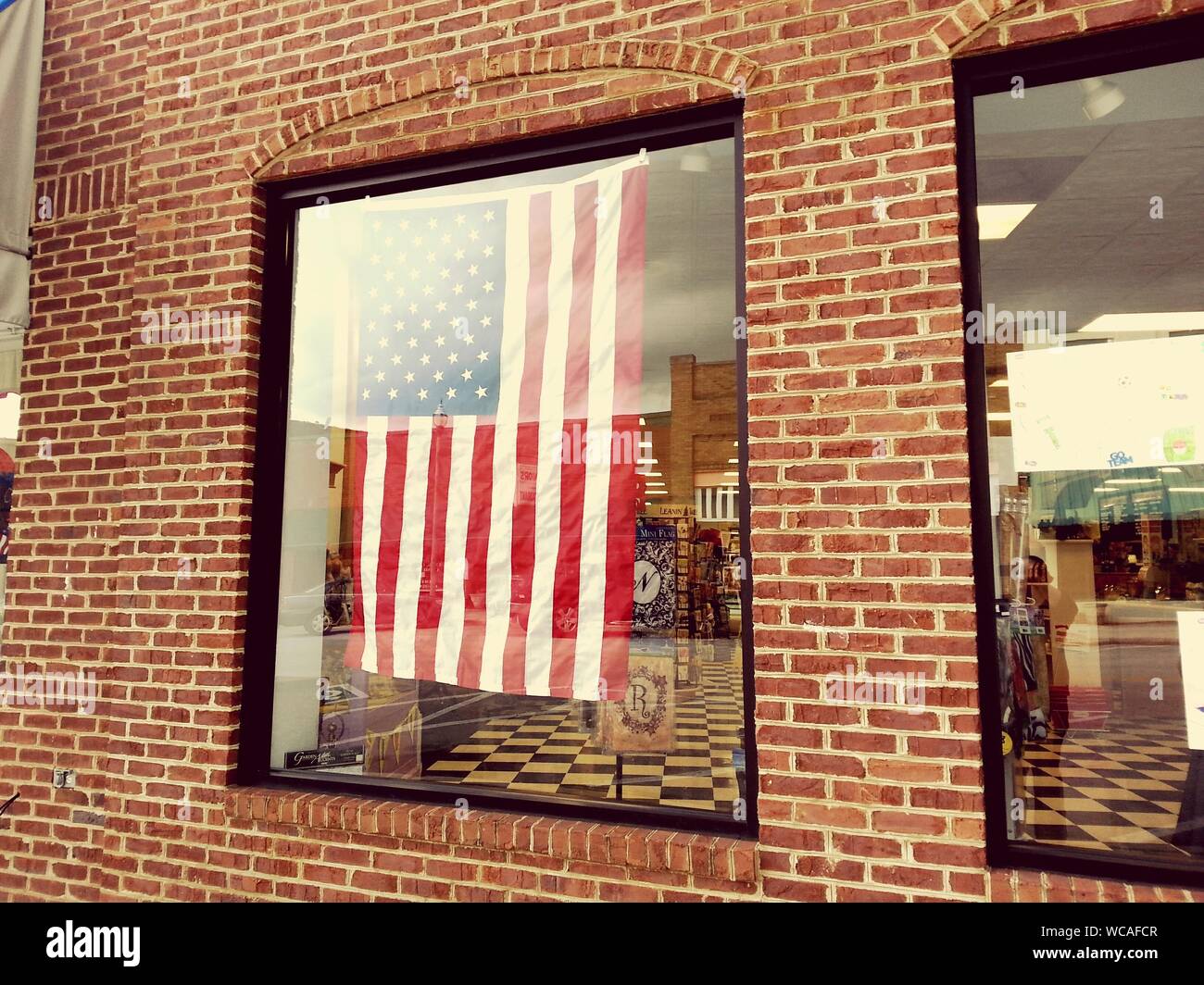 Flag hanging from building hi-res stock photography and images - Alamy