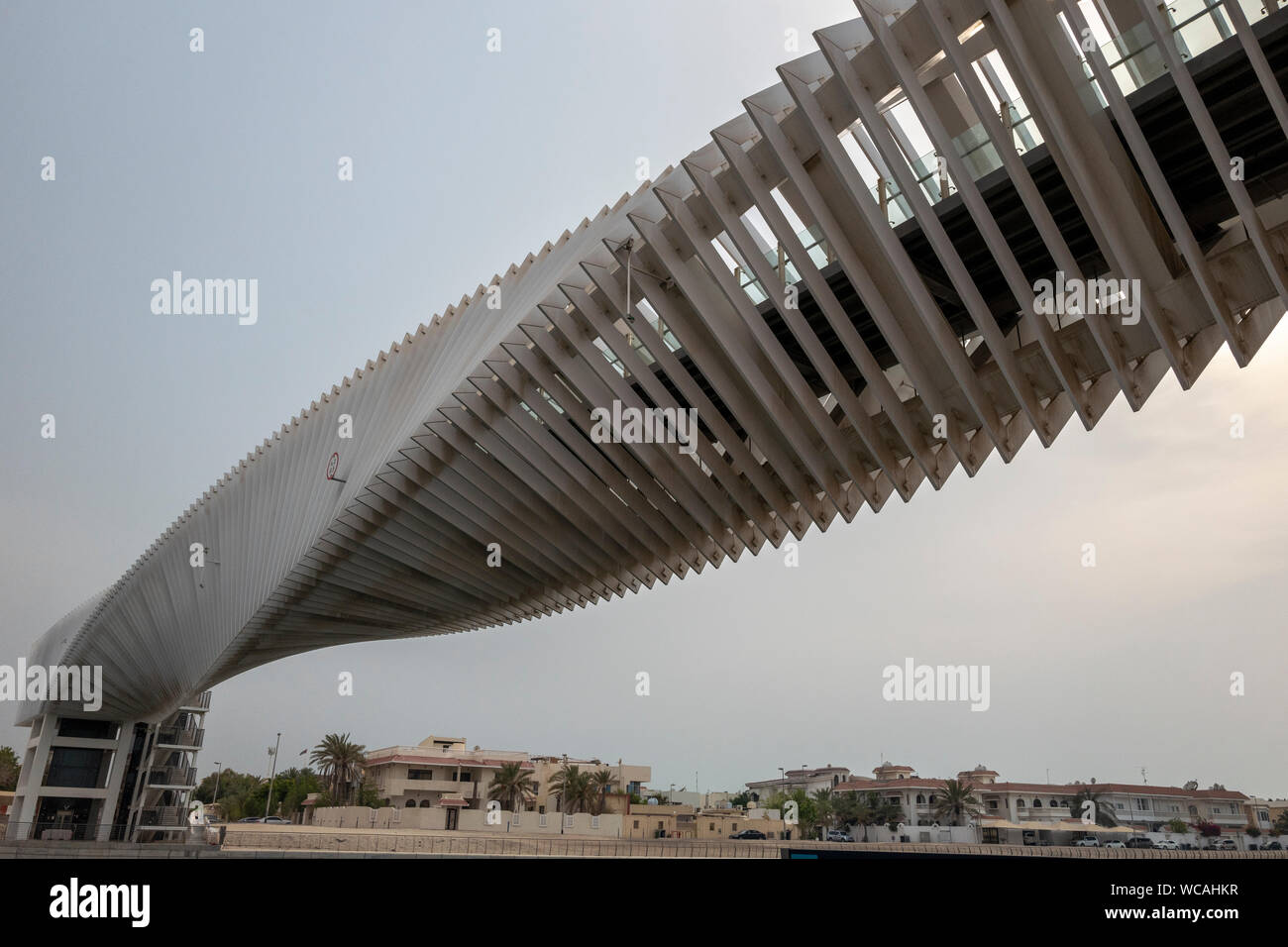 The iconic twisted pedestrian bridge over the Dubai Water Canal in ...
