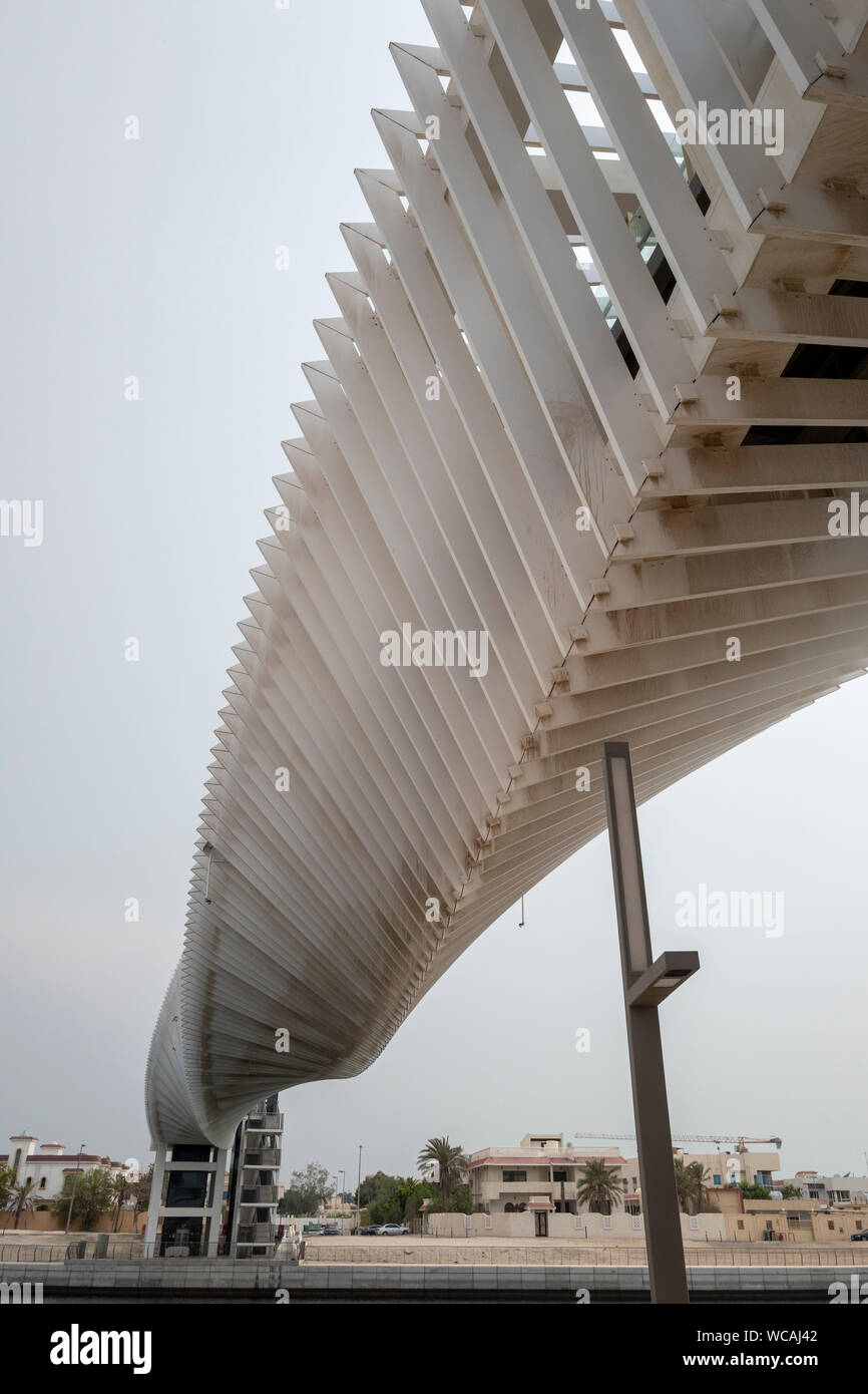 The iconic twisted pedestrian bridge over the Dubai Water Canal in ...