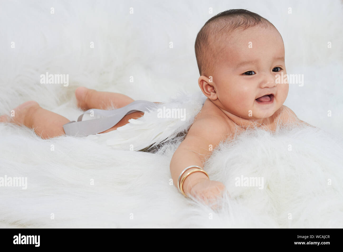 Baby lying on fur rug hi-res stock photography and images - Alamy