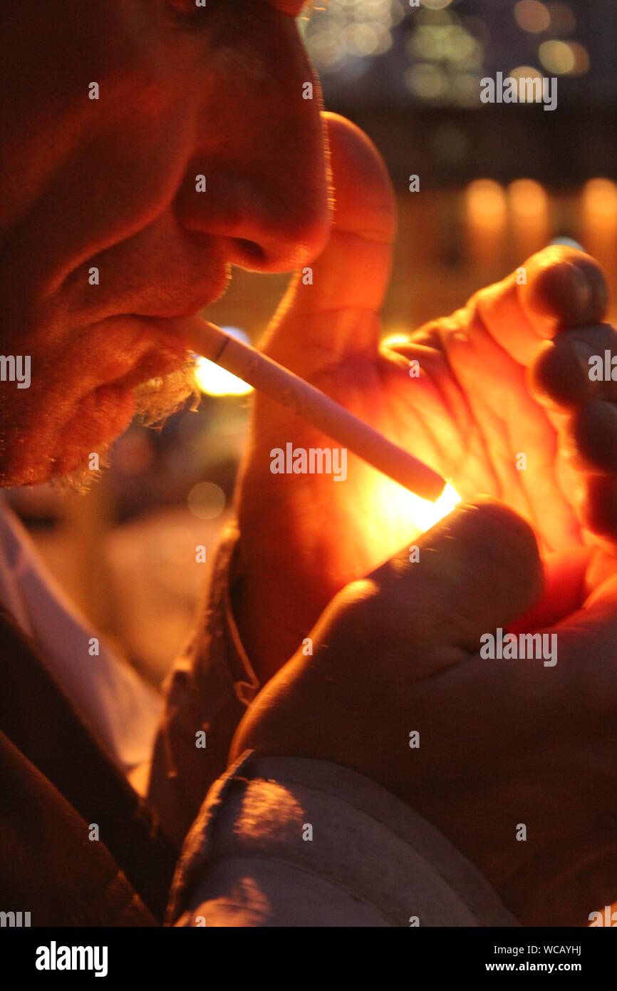 Man lighting up cigarette hi-res stock photography and images - Alamy