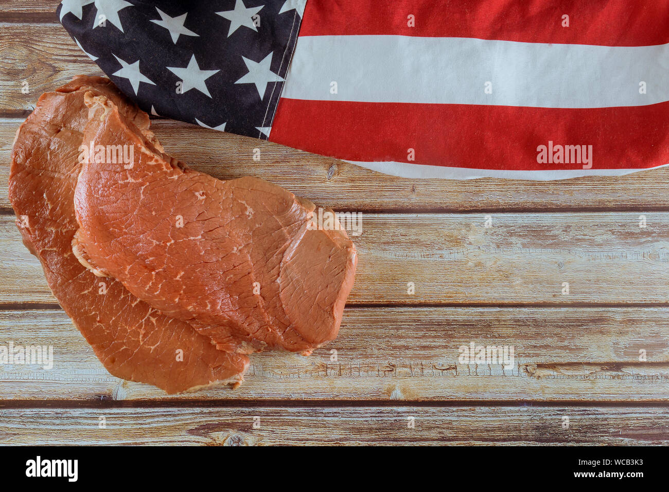Fresh American beef steak strip loin steak on a wood background and ...