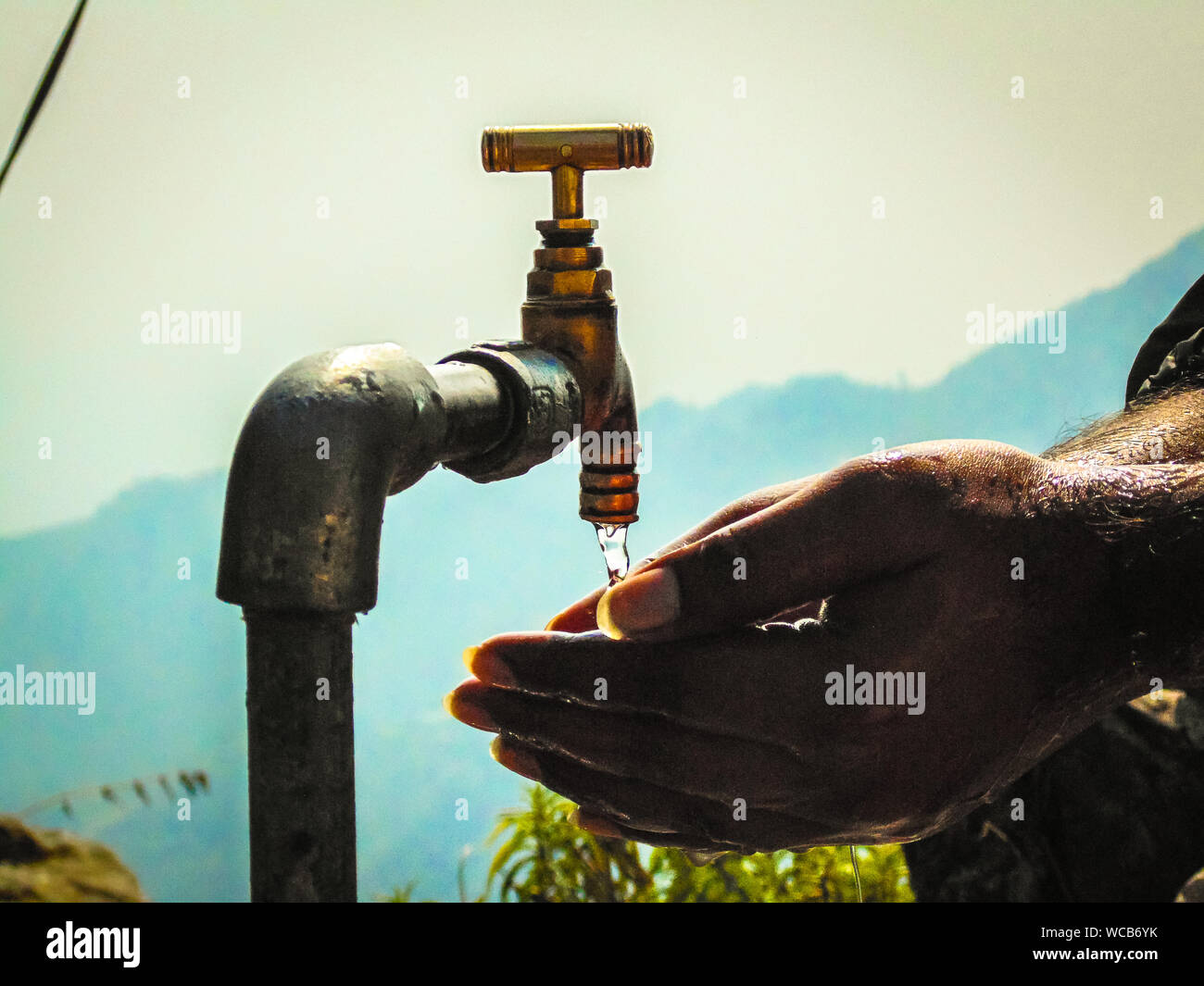 Cupped hands under tap hi-res stock photography and images - Alamy