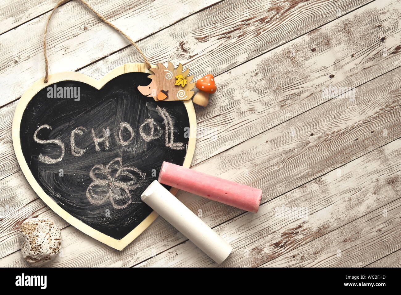 Back to school concept. Word school handwritten with chalk on the heart ...