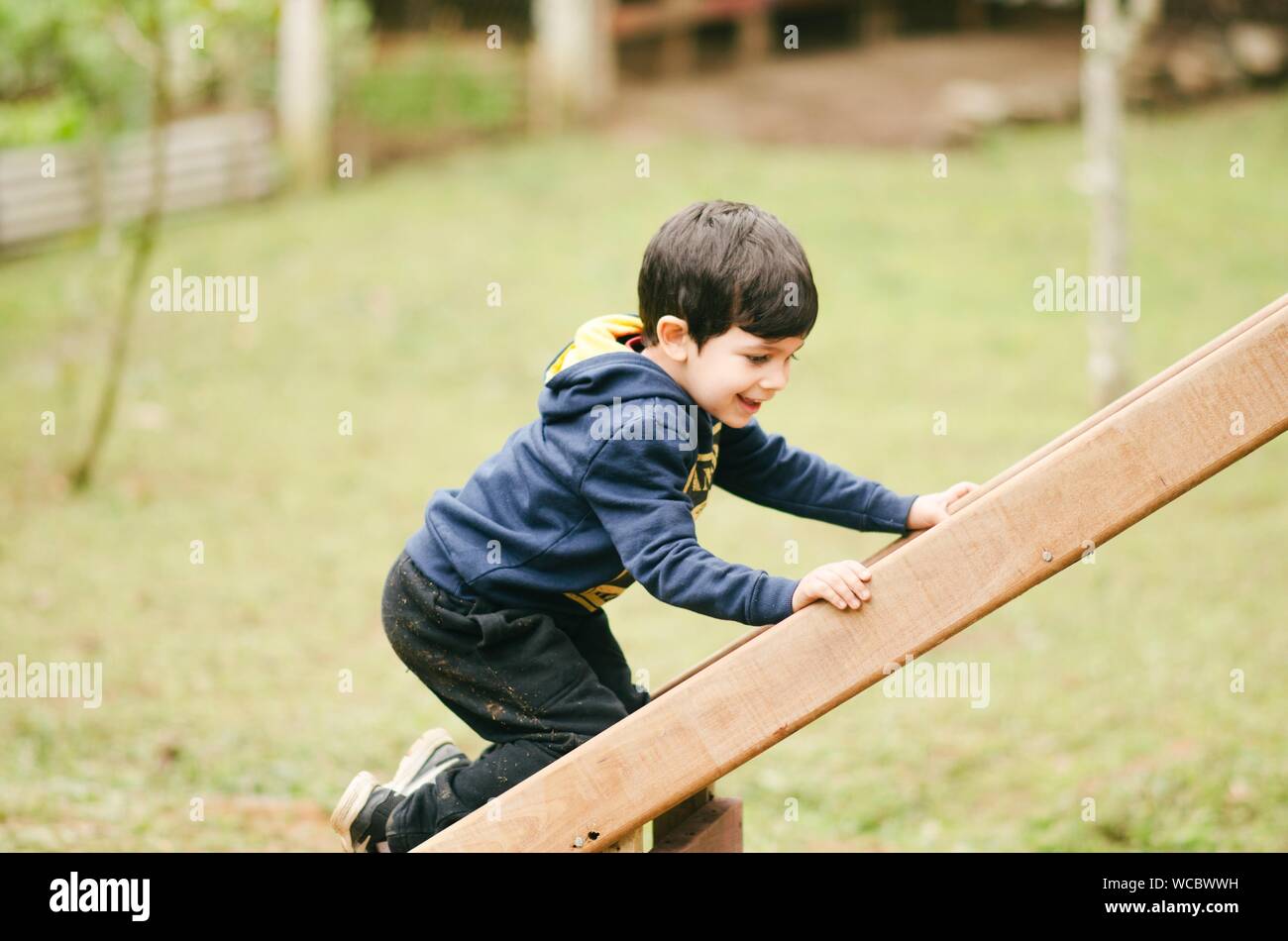 Boy playing on slide hi-res stock photography and images - Alamy