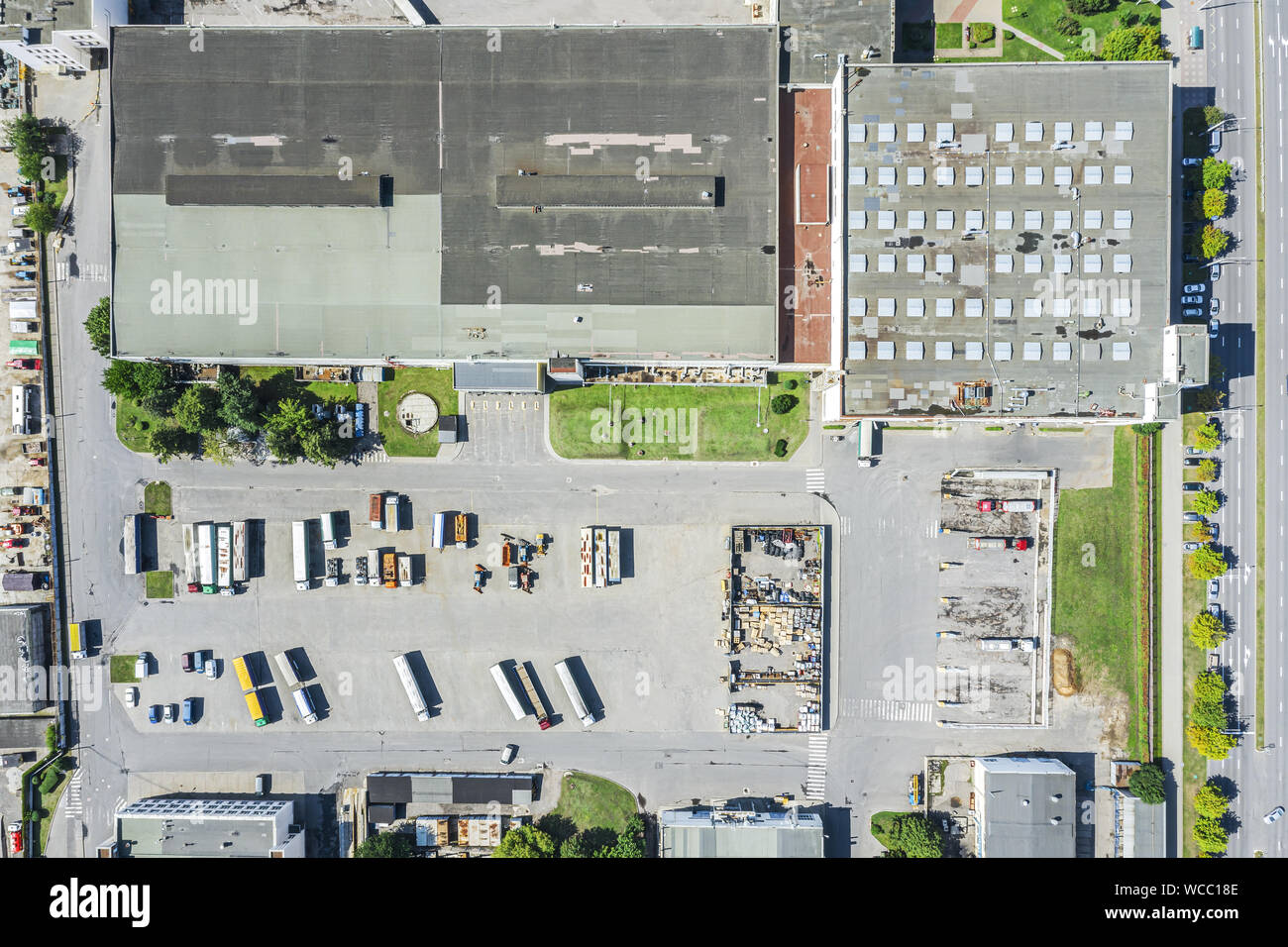 aerial top view of modern industrial building and warehouse with parked ...