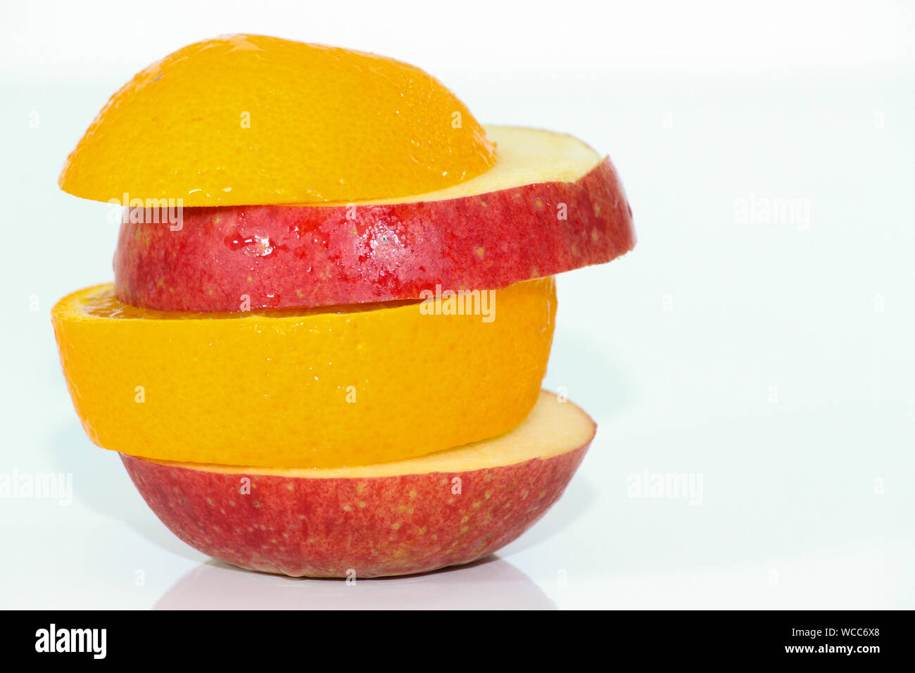 Stack Of Sliced Fruits Against White Background Stock Photo - Alamy