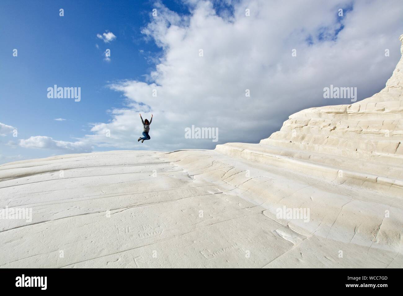 Woman jumping rock formation hi-res stock photography and images - Alamy