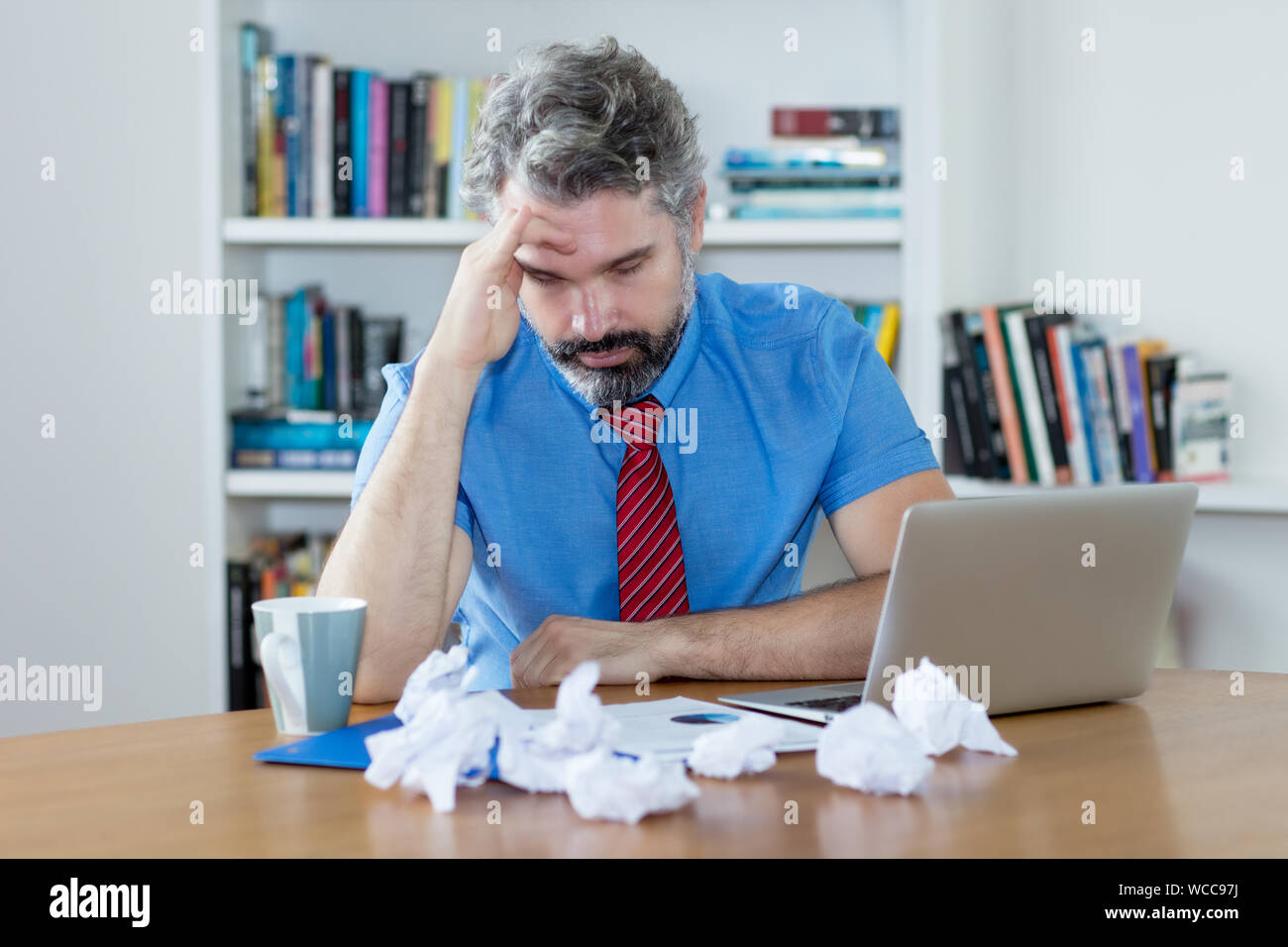 Stressed and overworked mature businessman at office Stock Photo - Alamy