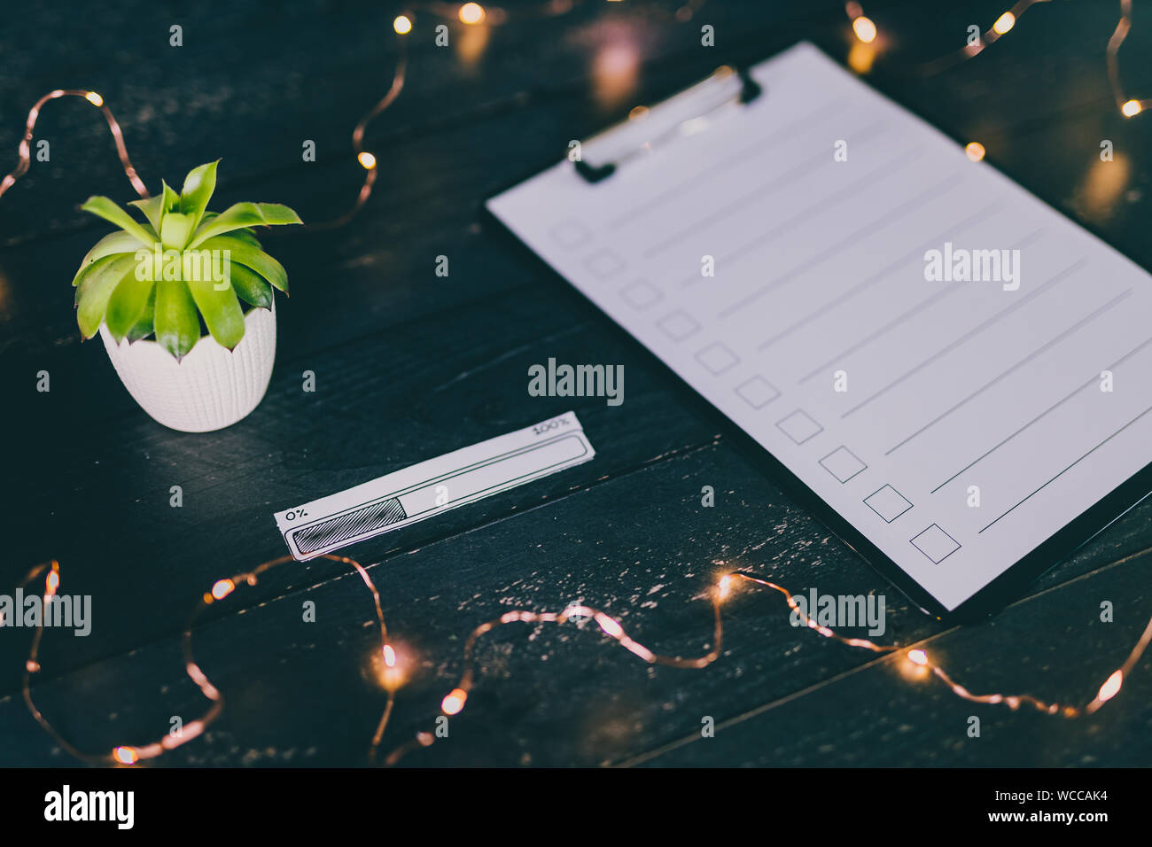 clipboard with blank list with cases to tick off on wooden desk with ...