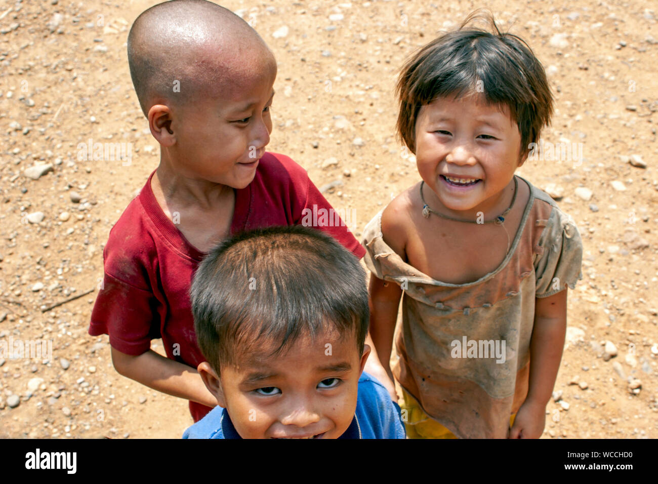 Three Happy Young Asian Children Living In Poverty Enjoy Their Day On A Three Happy Young Asian Children Living In Poverty Enjoy Their Day On A