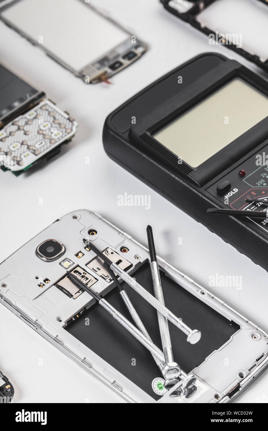 disassembled mobile phone and tools on white background Stock Photo - Alamy