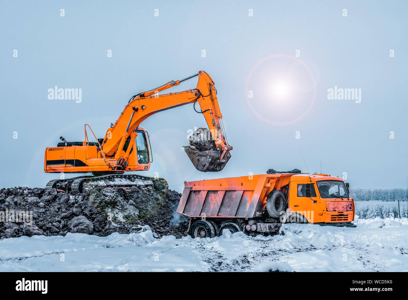 Excavator is loading excavation to the truck. Excavators are heavy ...