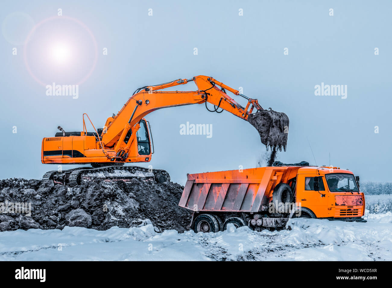 Excavator is loading excavation to the truck. Excavators are heavy ...