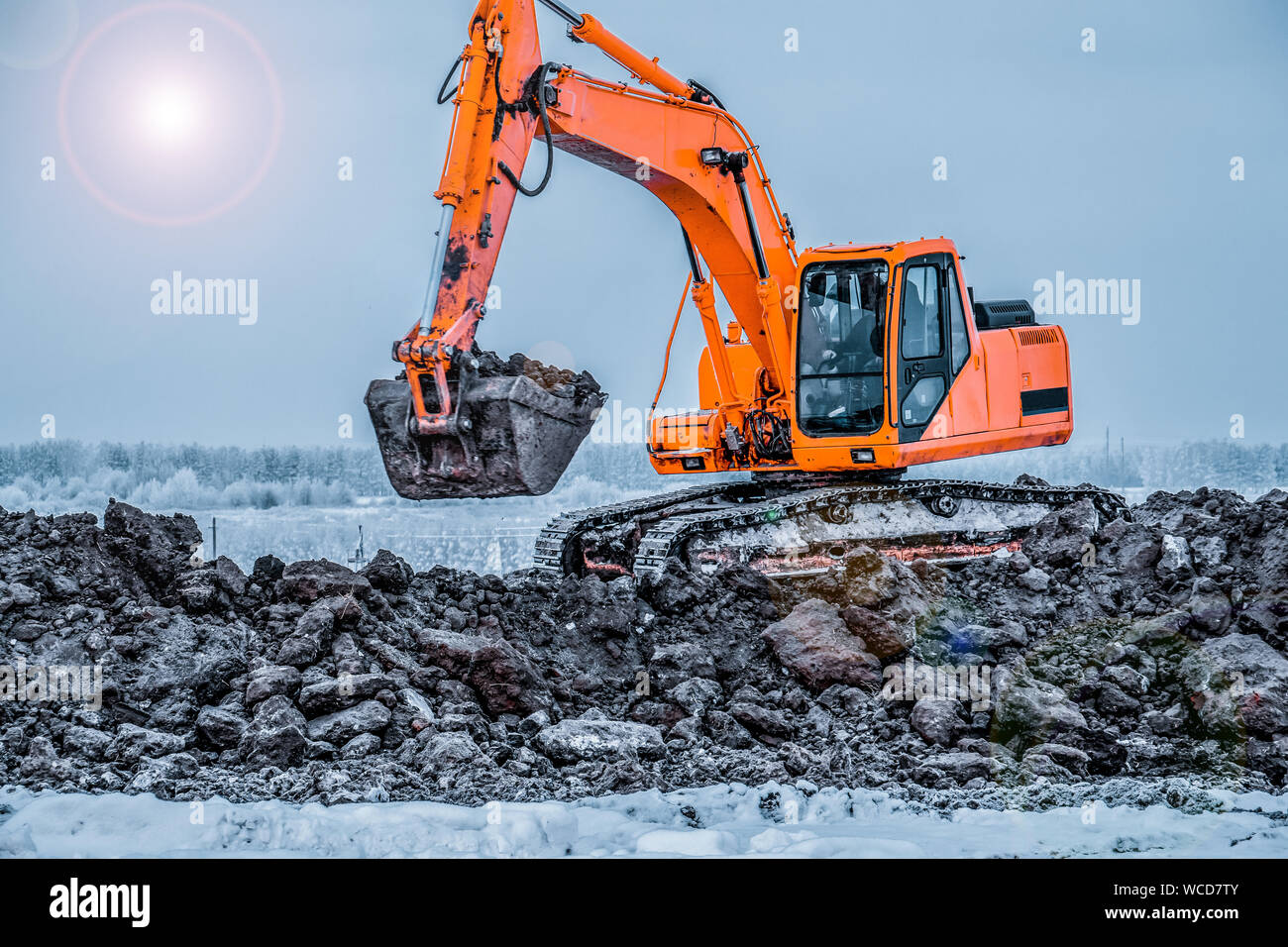Excavators and heavy machinery in the works of stone movement in a ...