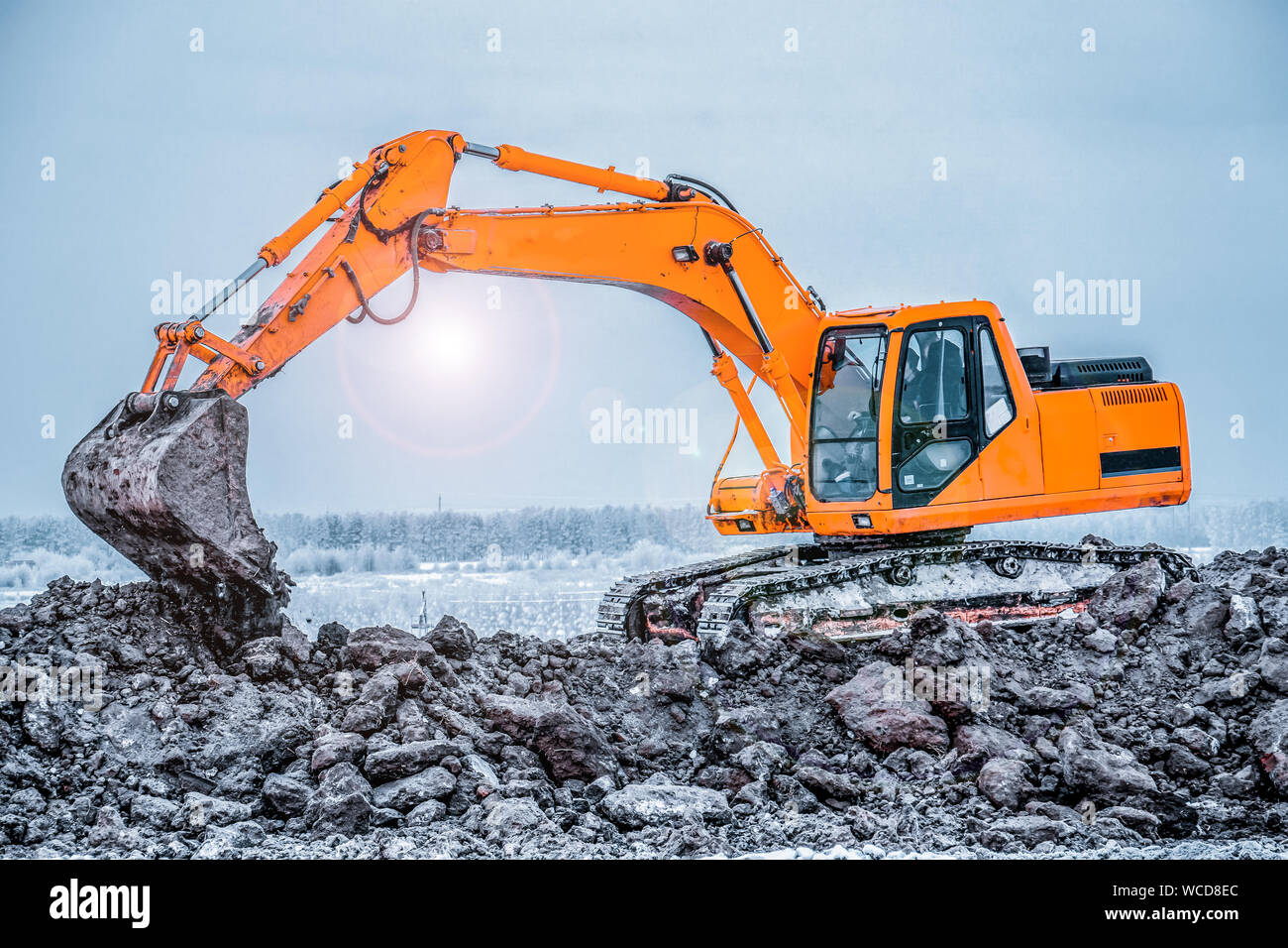 Excavators and heavy machinery in the works of stone movement in a ...