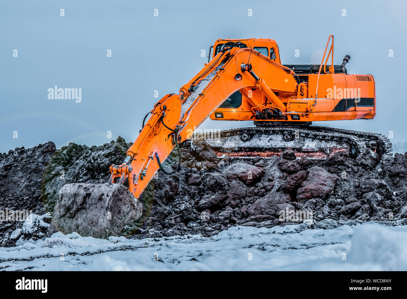 Excavators and heavy machinery in the works of stone movement in a ...