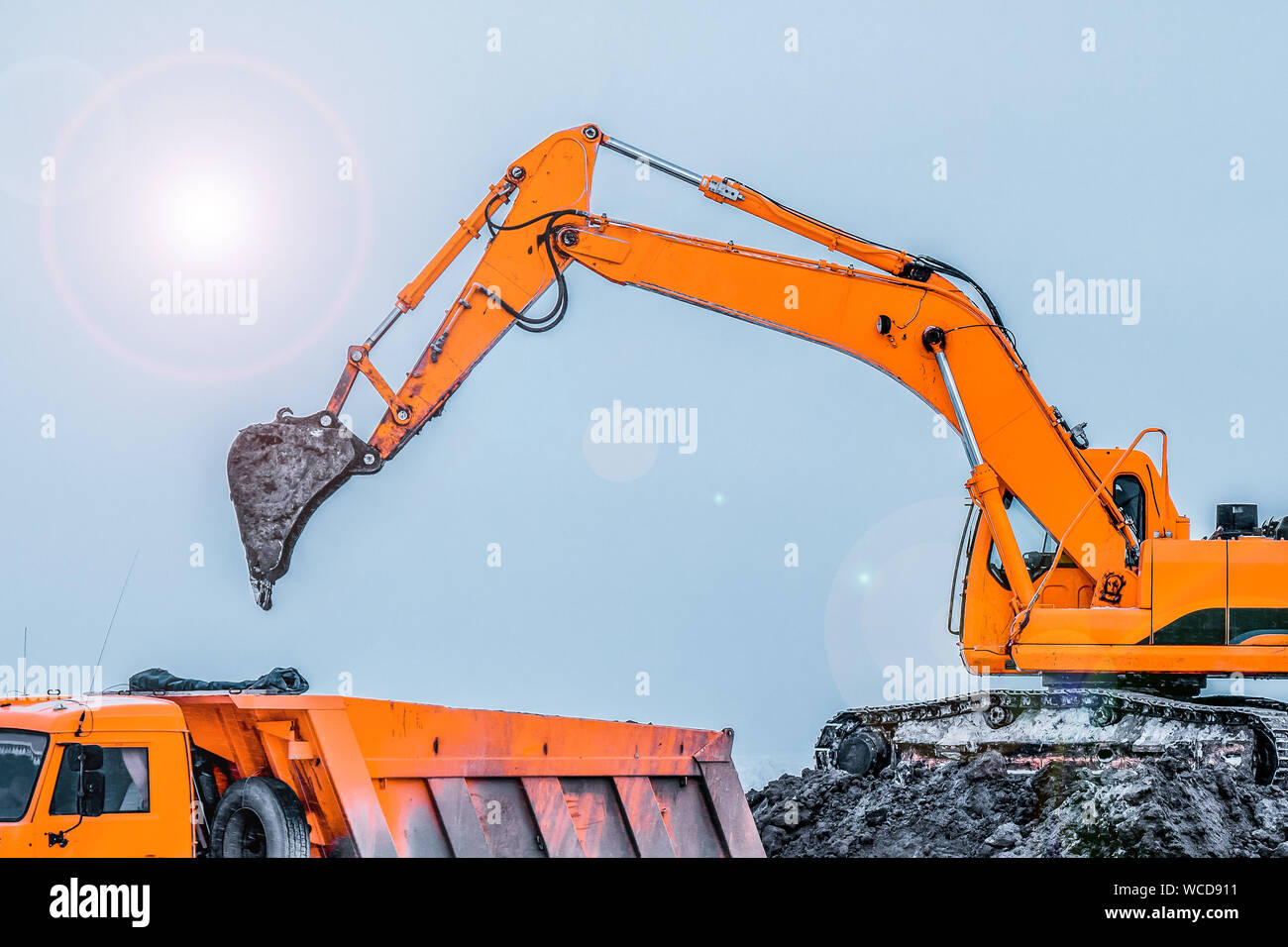 Excavators and heavy machinery in the works of stone movement in a ...