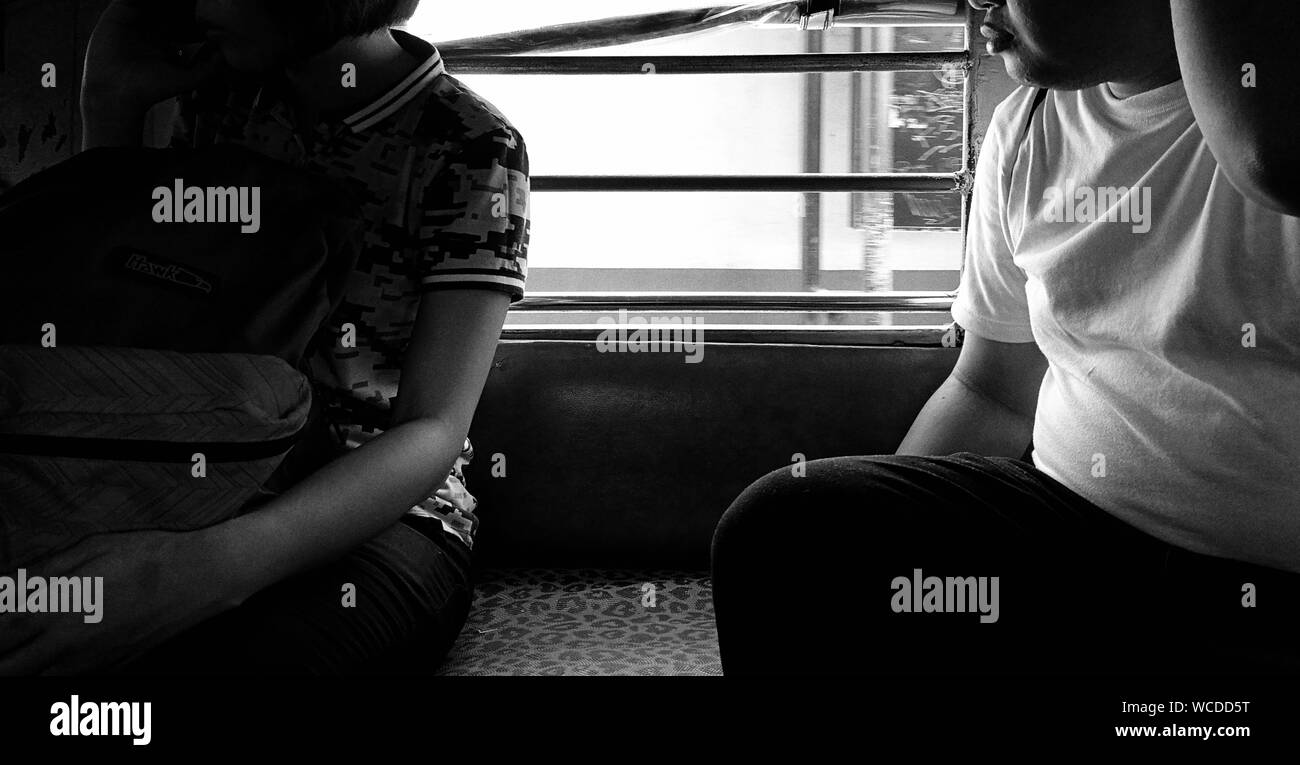 Two men sitting in train Black and White Stock Photos & Images - Alamy