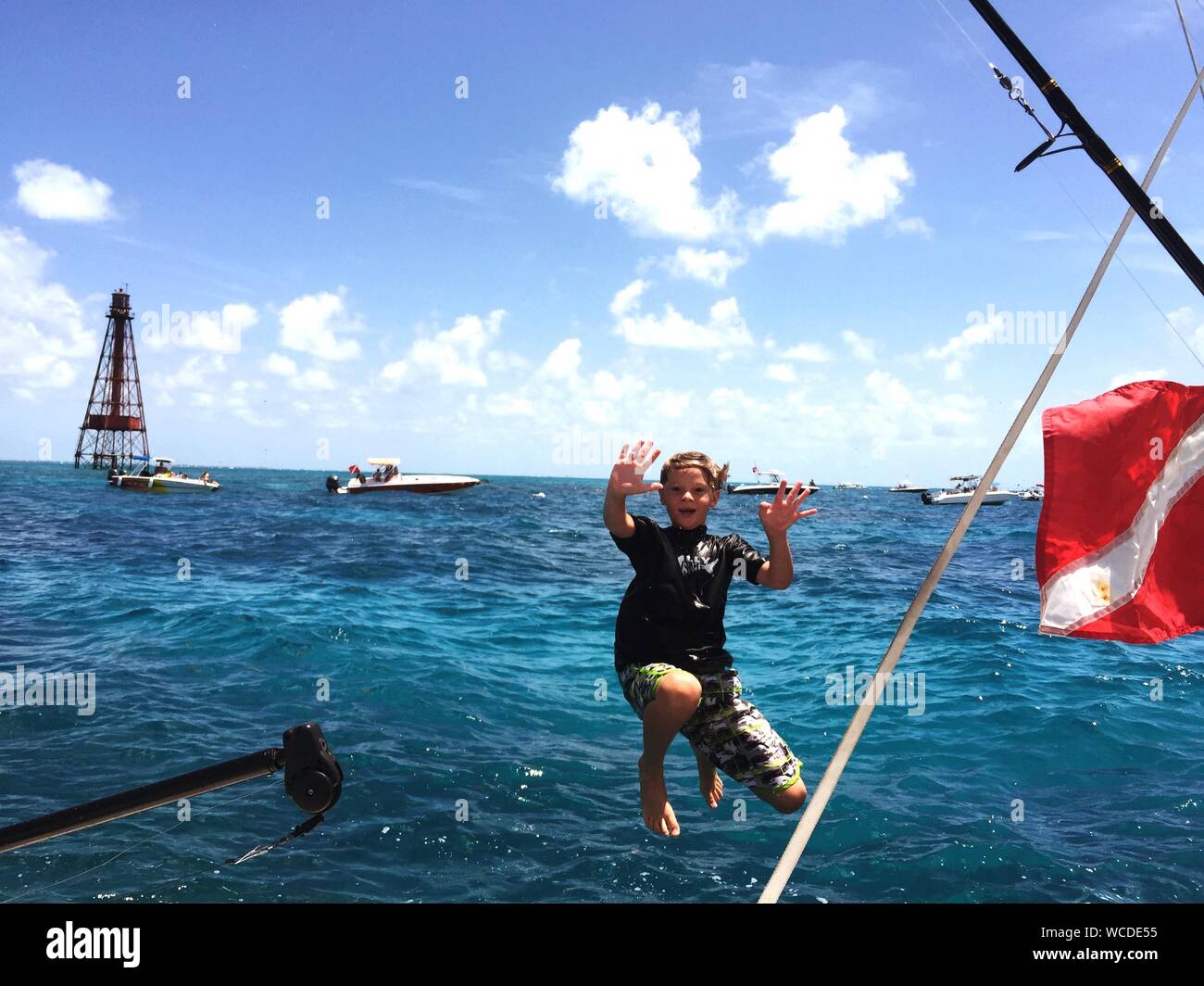 Boy jumping boat hi-res stock photography and images - Alamy
