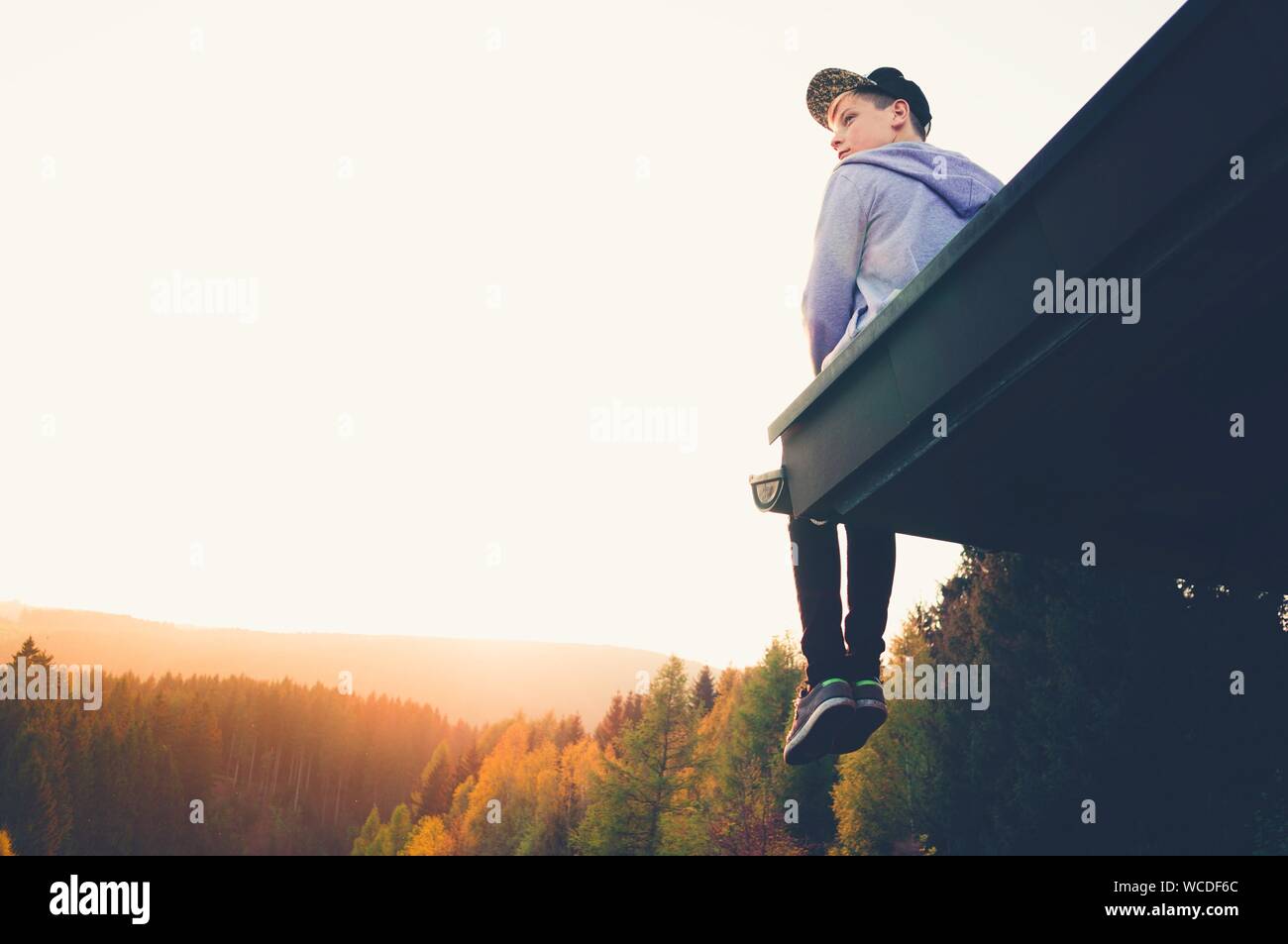 Man sitting on rooftop hi-res stock photography and images - Alamy