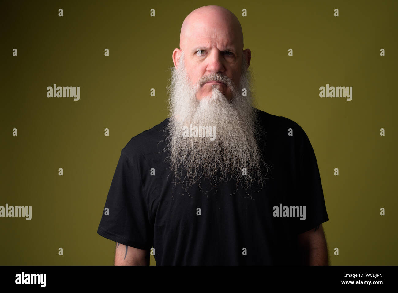 Angry mature bald man with long gray beard Stock Photo - Alamy