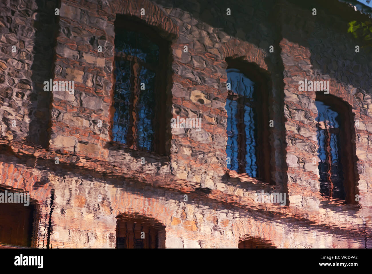 Ancient brick building reflected in the water surface Stock Photo - Alamy