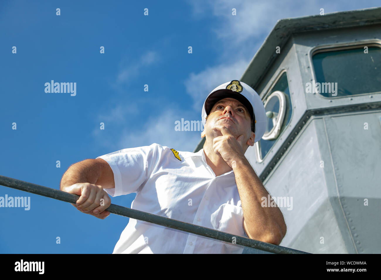The thinking captain standing on the gallery of navigation bridge of ...