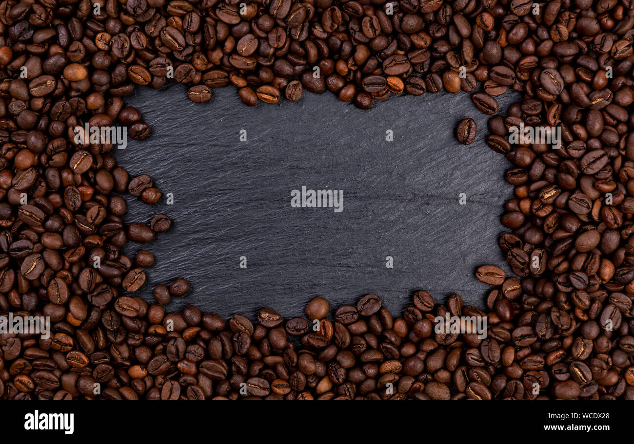 Frame made of roasted coffee beans on black table, top view Stock Photo ...