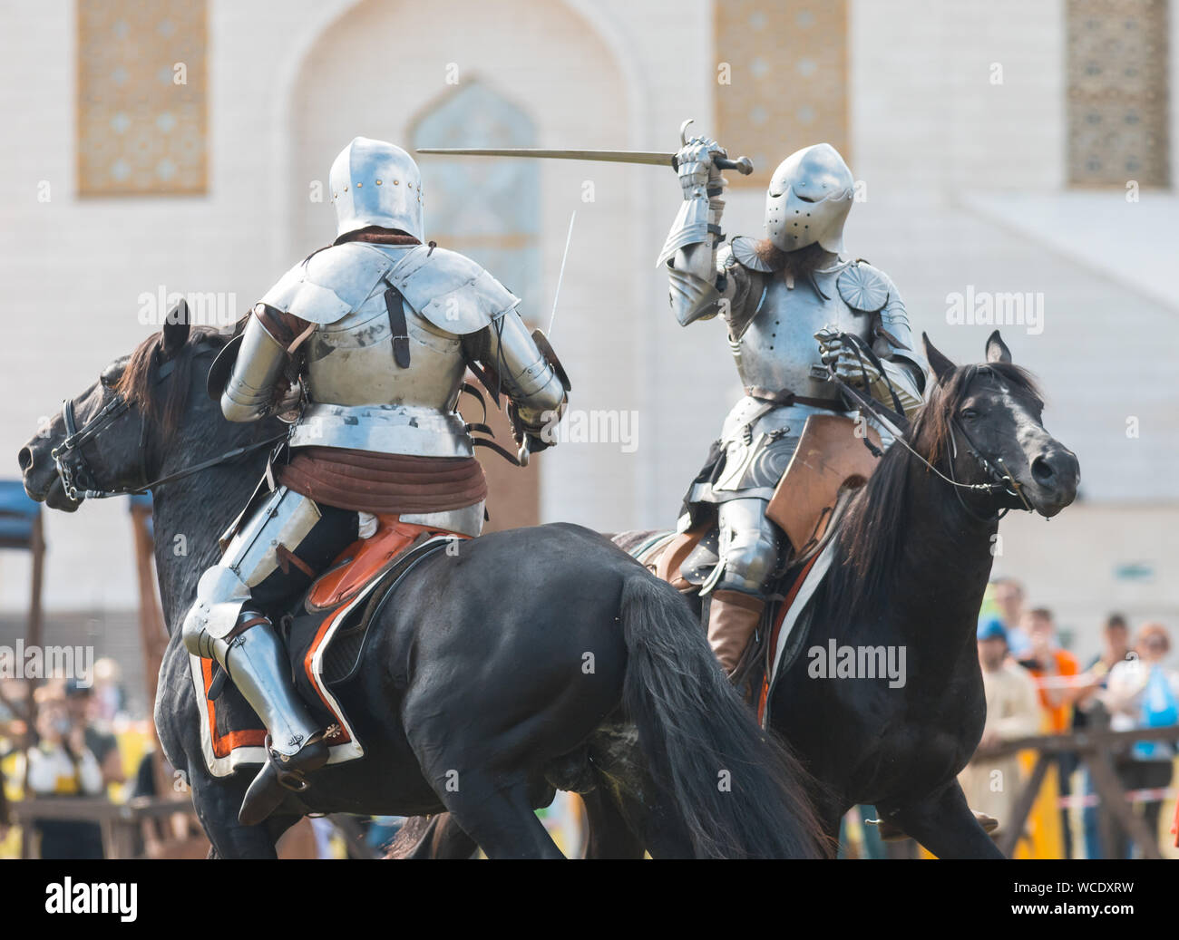 BULGAR, RUSSIA 11-08-2019: Two knights having a fight on metal swords ...