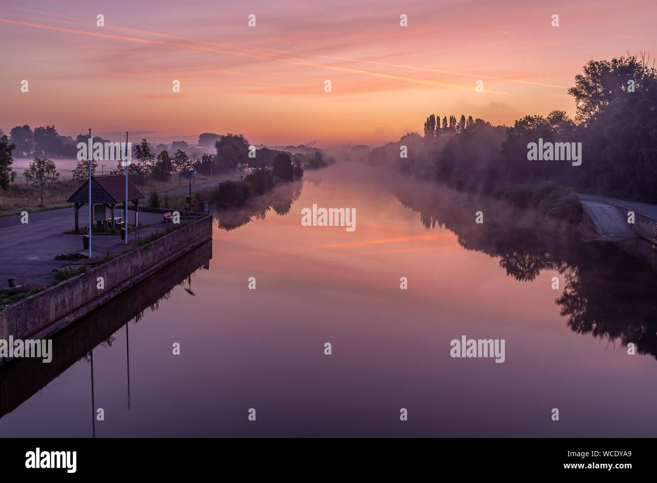 Just before sunrise at the bridge over the river Lys in Lauwe ...