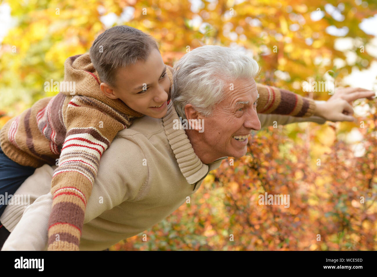 Happy grandfather and grandson having fun in park Stock Photo - Alamy