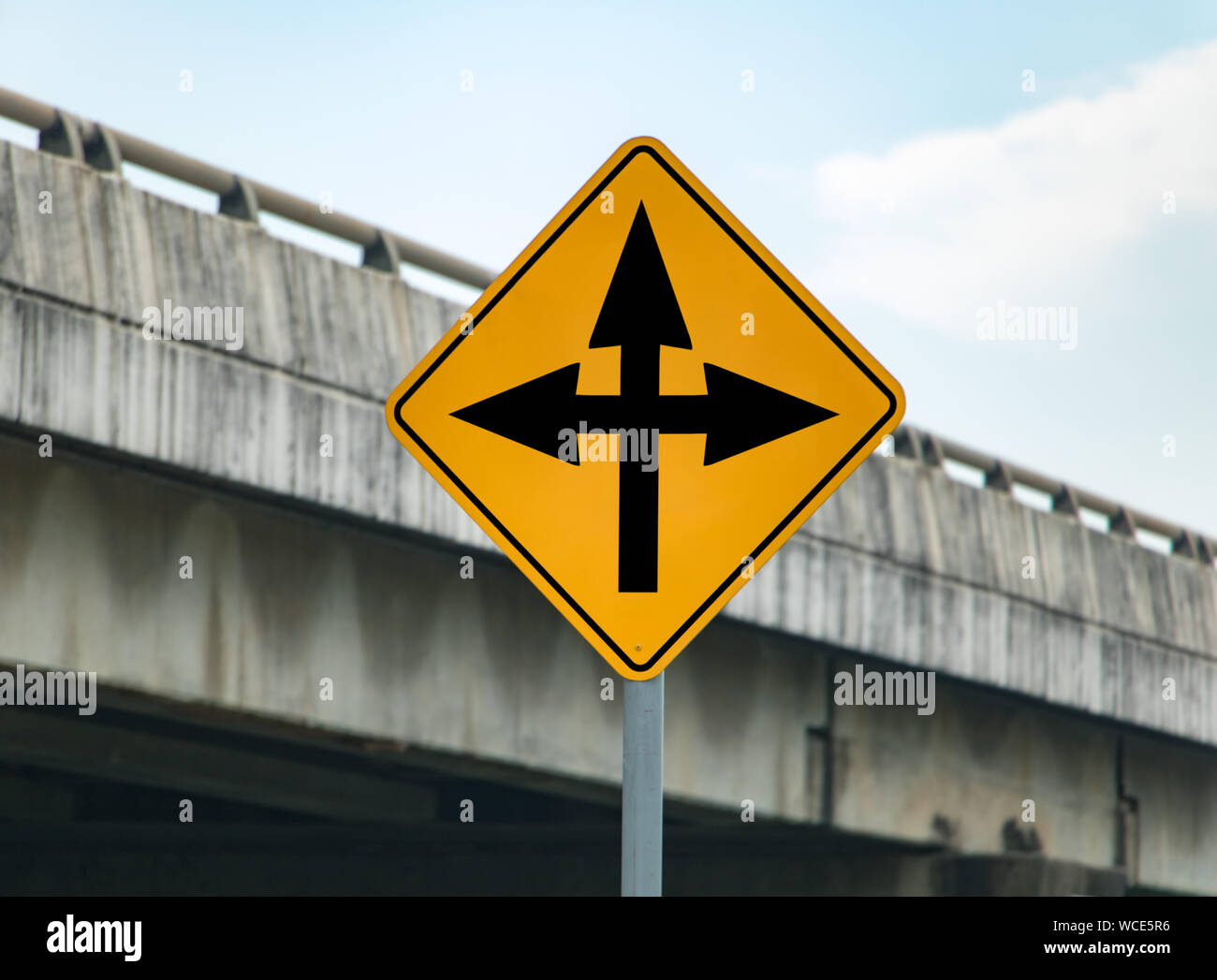 Road sign with arrows informs about crossing on the road. Warning of ...
