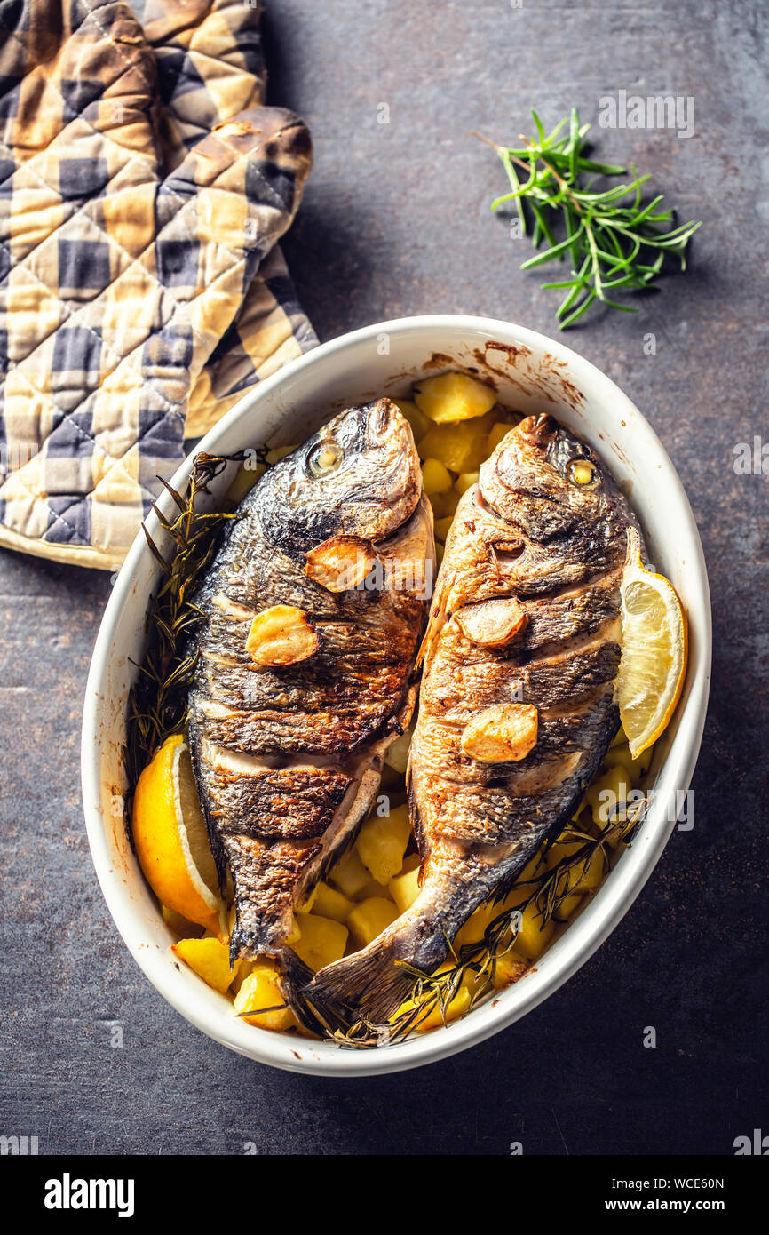 Roasted mediterranean fish bream with potatoes rosemary and lemon Stock ...
